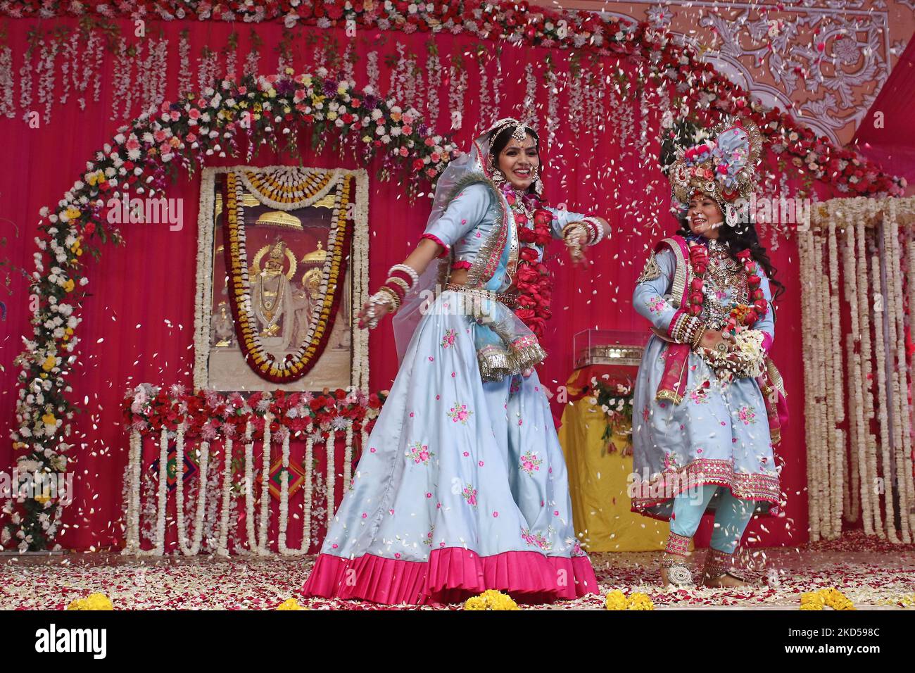 Artists dressed as Lord Krishna and Goddess Radha perform during the ...