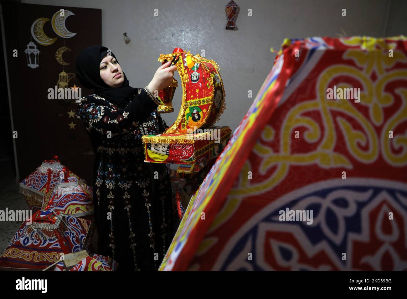 Palestinian woman Reham Shurab makes a traditional lantern, called a ...