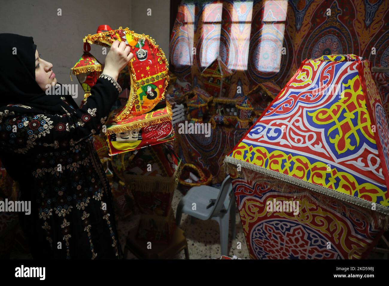 Palestinian woman Reham Shurab makes a traditional lantern, called a ...
