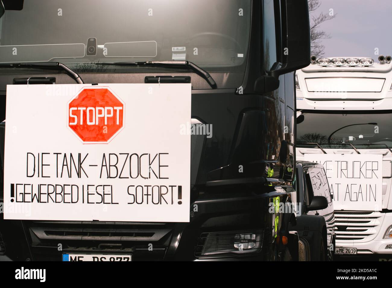 sign of "stop ripping of tank" is seen hanging in front of a trucker ...