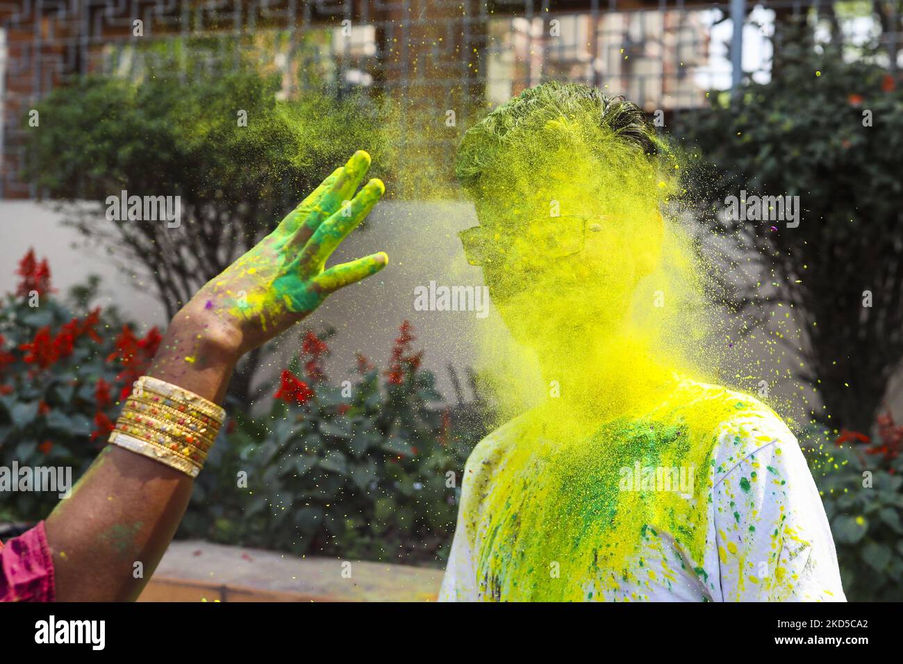 People spread abir (powdered colour) celebrating Dol Purnima festival ...