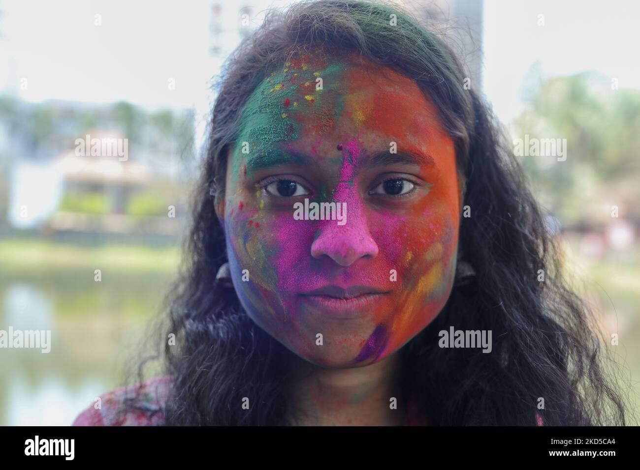 People spread abir (powdered colour) celebrating Dol Purnima festival in Dhaka, Bangladesh on ...