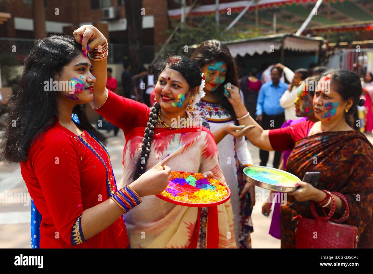 People spread abir (powdered colour) celebrating Dol Purnima festival in Dhaka, Bangladesh on ...