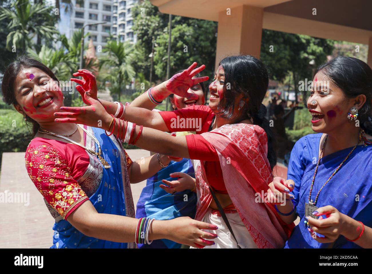 People spread abir (powdered colour) celebrating Dol Purnima festival ...