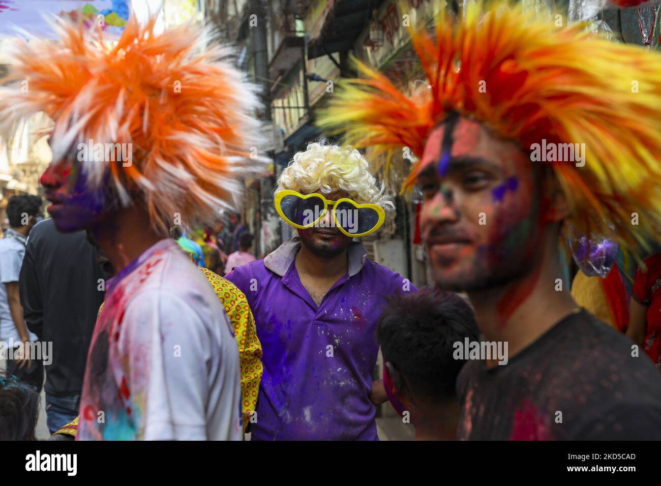 People spread abir (powdered colour) celebrating Dol Purnima festival in Dhaka, Bangladesh on ...