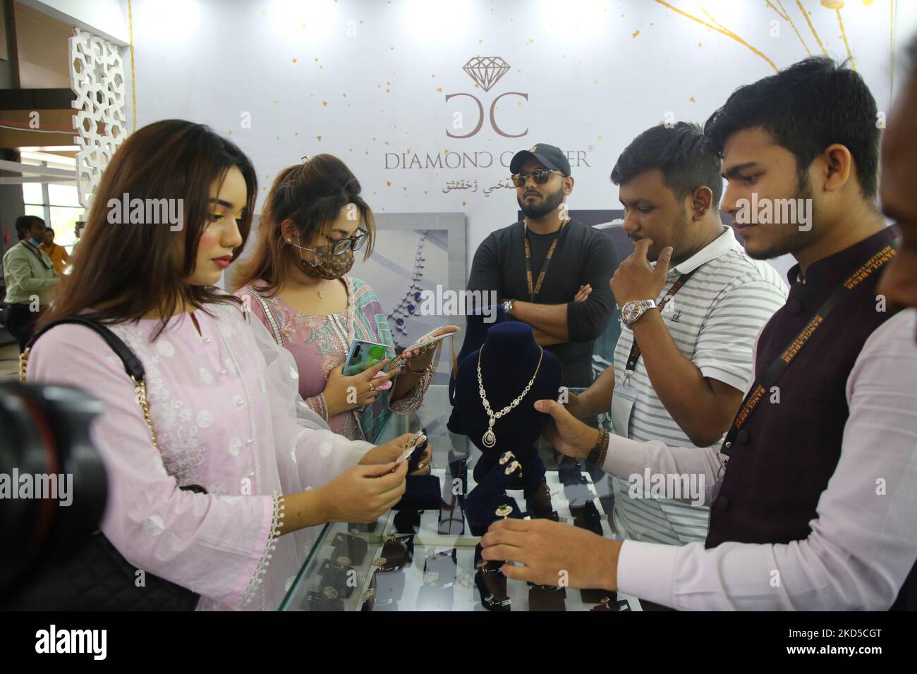 A visitor looks at jewellery ornaments on display at a stall at the ...