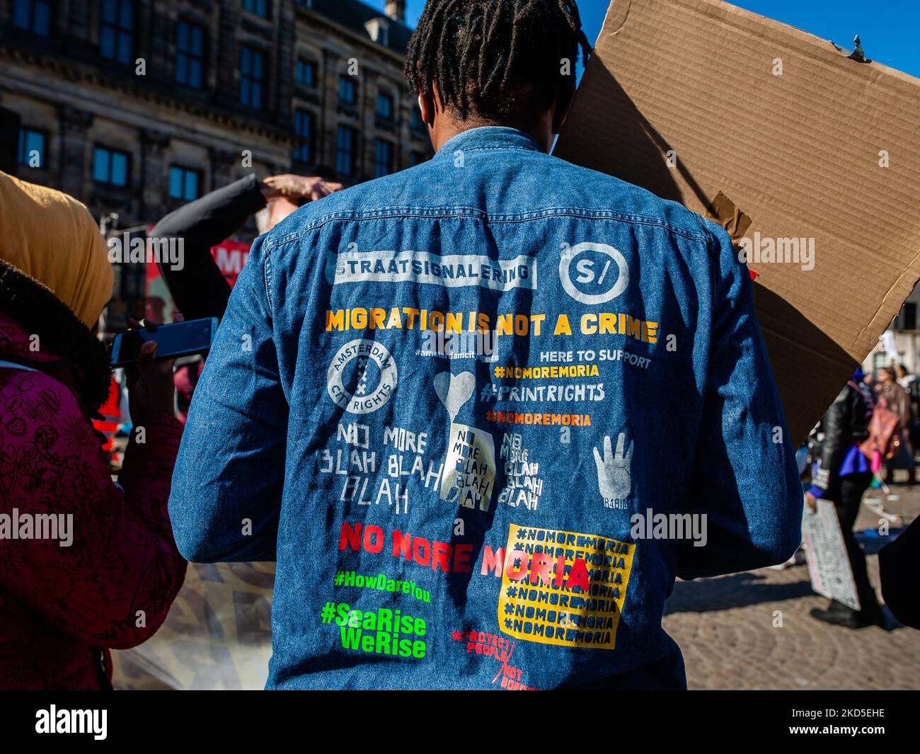 A Black man is wearing a t shirt with messages against racism and ...