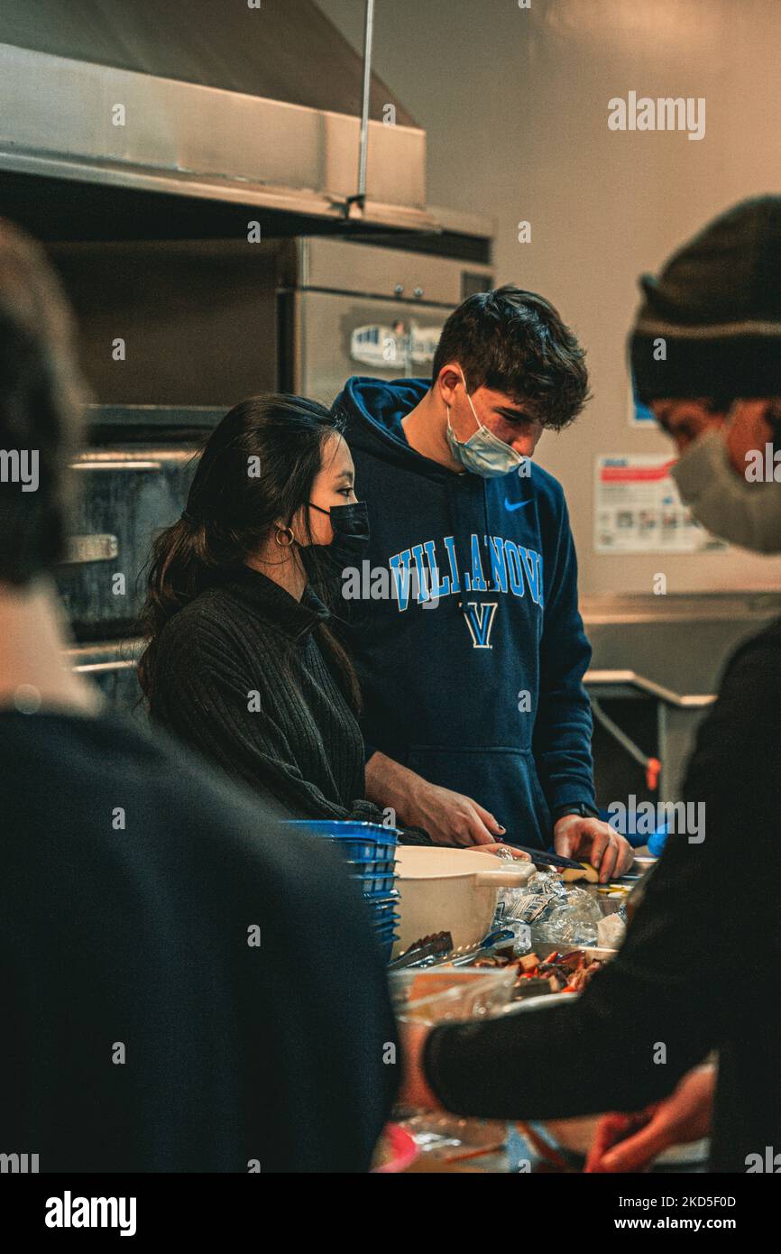Man and woman cooking together to help feed the homeless Stock Photo ...