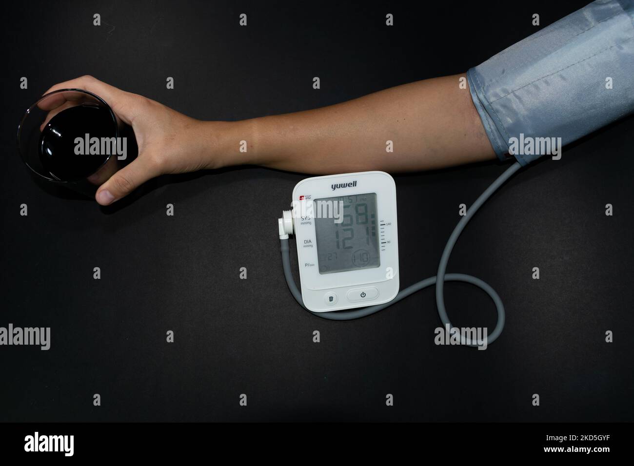 young woman measuring her blood pressure, alcoholic beverages and their ...