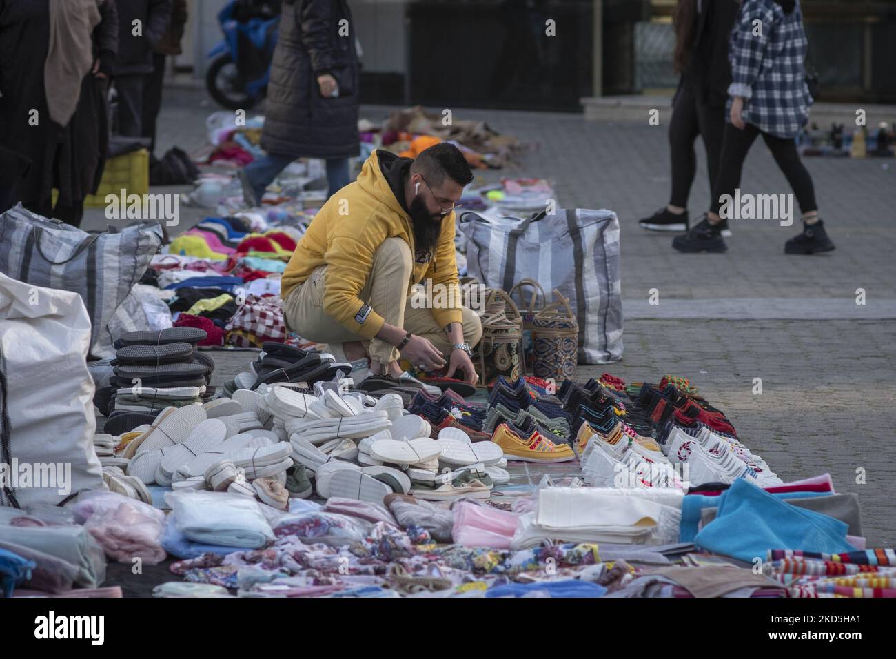 An Iranian vendor displays traditional handmade Kurdish shoes, Giveh ...