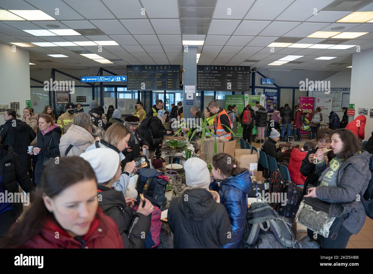 People rest at Chelm railway station after crossing the Poland-Ukraine ...