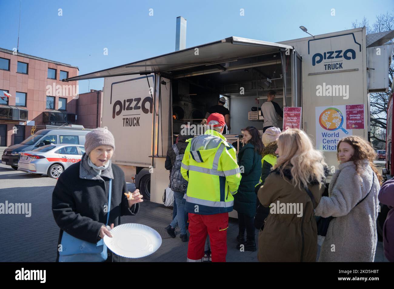 People rest at Chelm railway station after crossing the Poland-Ukraine ...