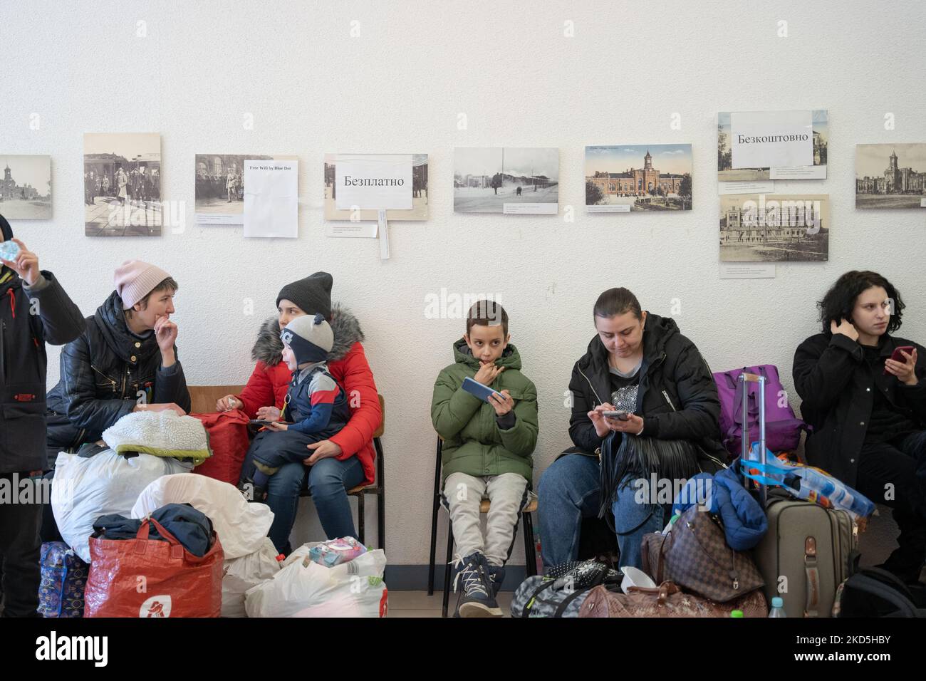 People rest at Chelm railway station after crossing the Poland-Ukraine ...