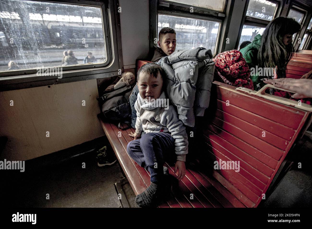 A boy sitting alone in the train. Ukrainian people, war refugees as ...