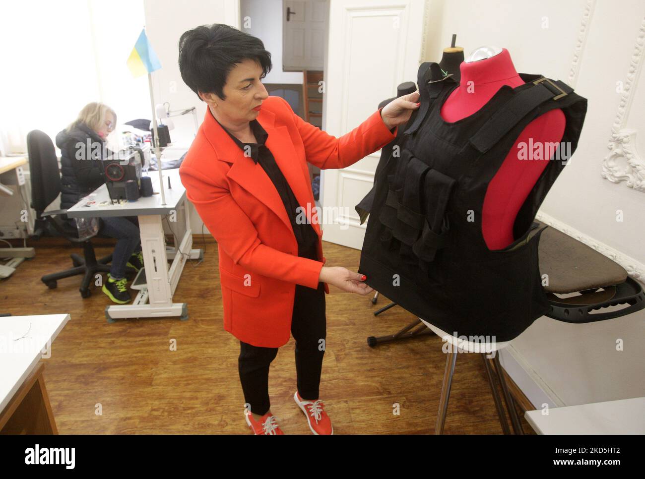 A woman works on bulletproof vests for servicemen of Ukrainian army in ...