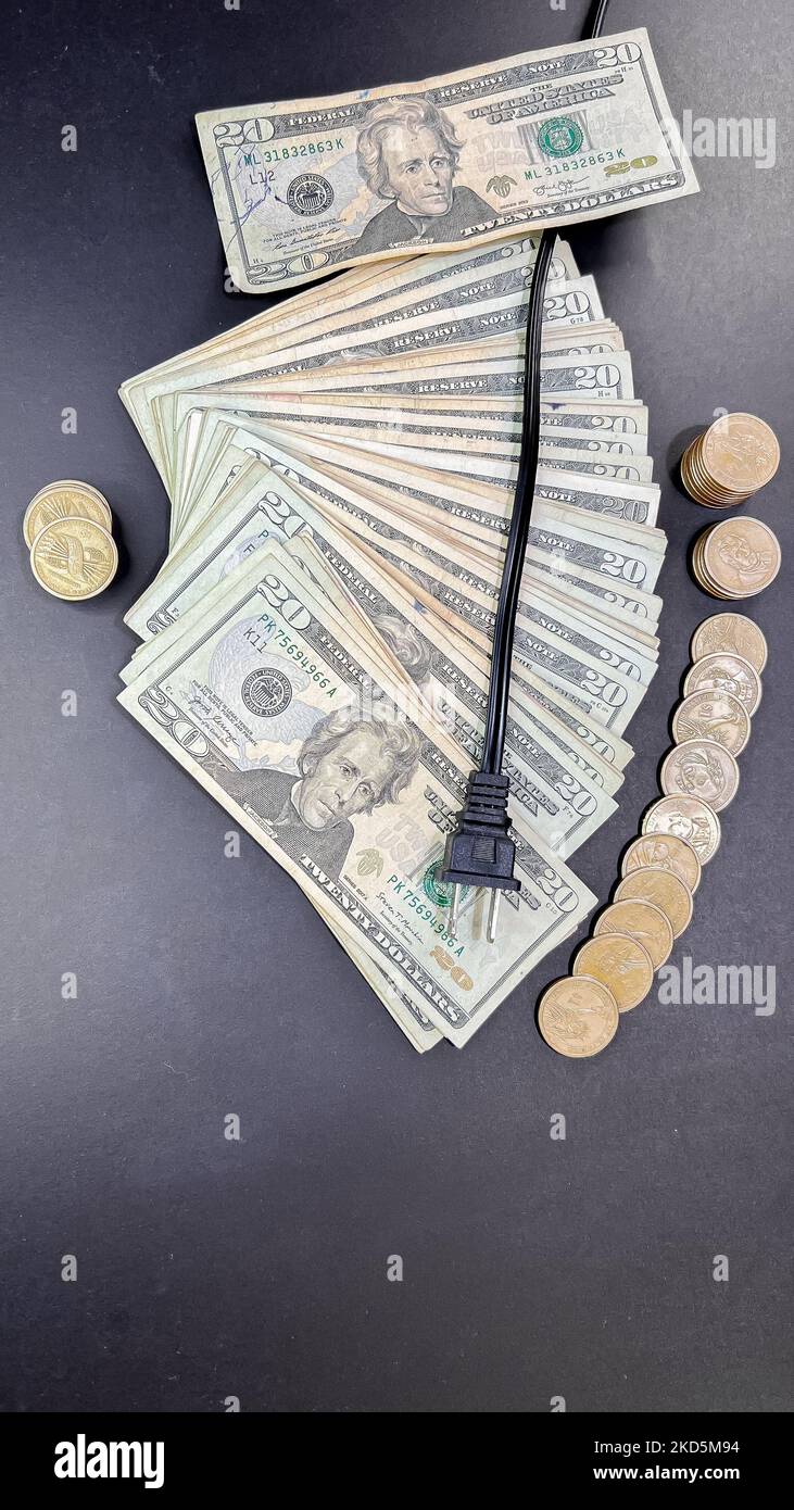 dollar bills and coins with an electric plug. expensive energy Stock ...