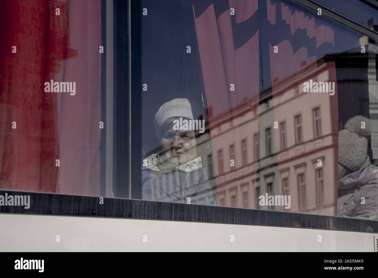 A woman looking out of the window. Close up at refugees from Ukraine in ...