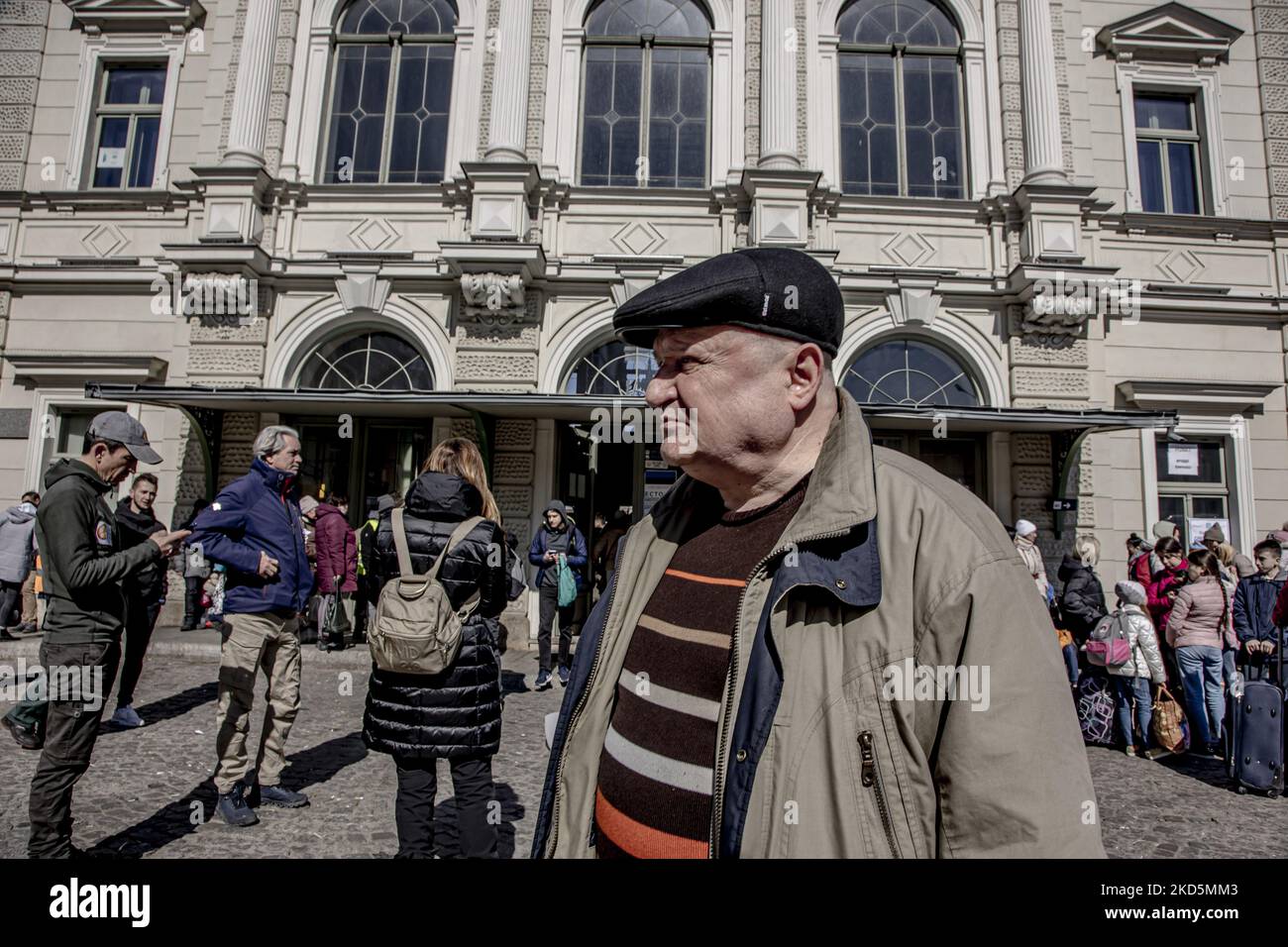 An old man refugee from Ukraine is going to board a bus. Civilians from ...