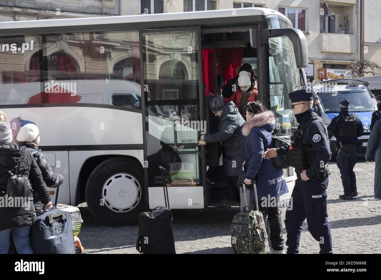 Crowd of people, refugees who fled Ukraine are seen getting in the bus ...