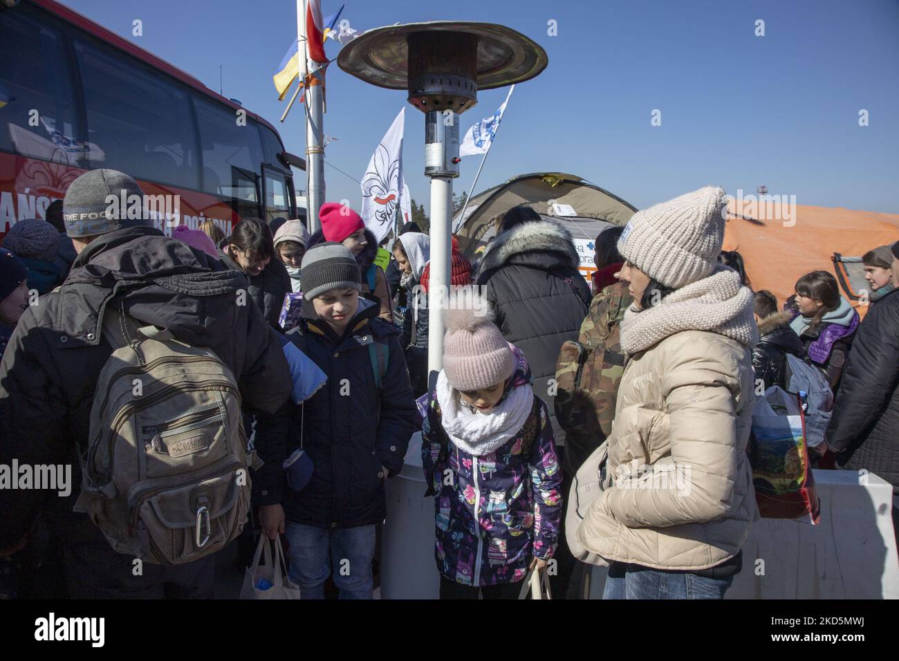 Refugees from Ukraine board the buses while the Polish firefighters ...