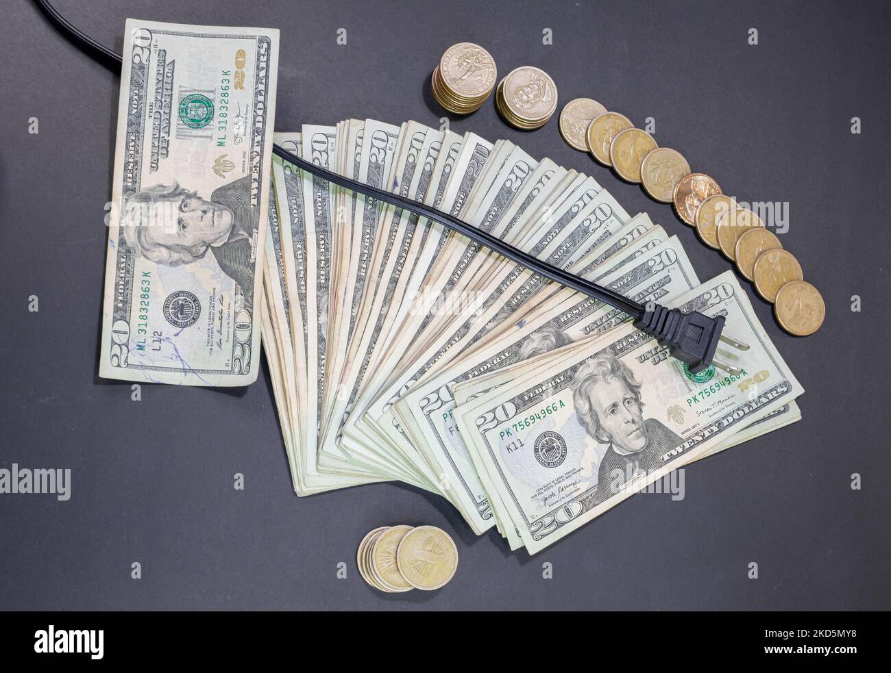 dollar bills and coins with an electric plug. expensive energy Stock ...