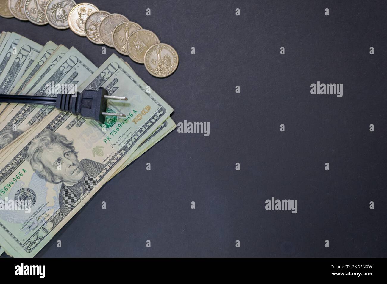 dollar bills and coins with an electric plug. expensive energy Stock ...