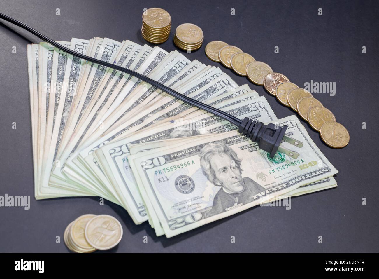 dollar bills and coins with an electric plug. expensive energy Stock ...