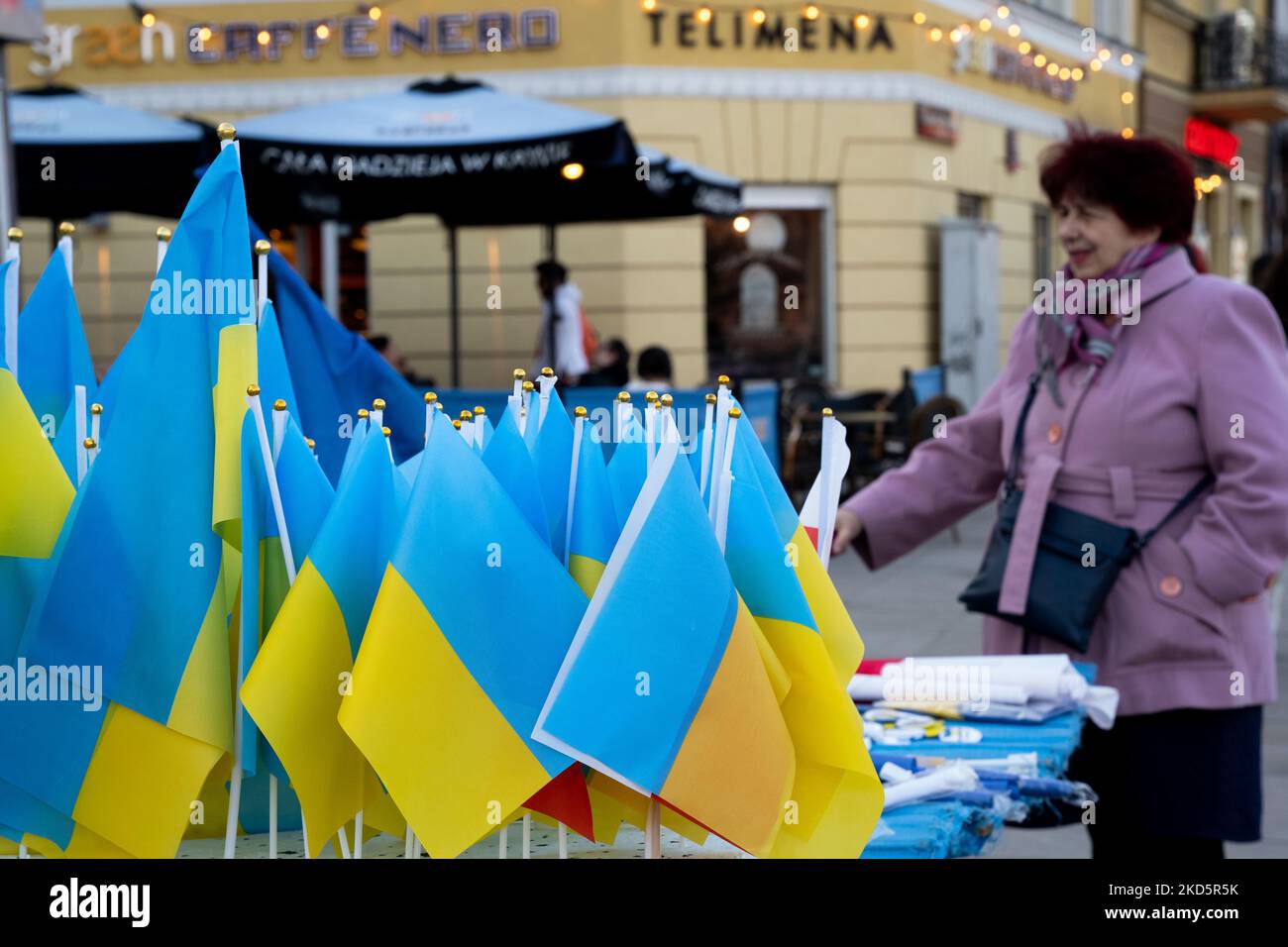 A vendor sells Ukrainian flags at Warsaw Old Town square in Warsaw ...