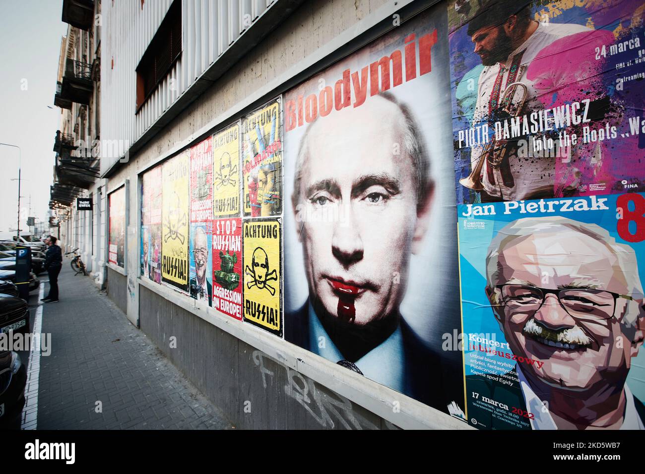 An anti-war poster with an image of Russian president Vladimir Putin is ...