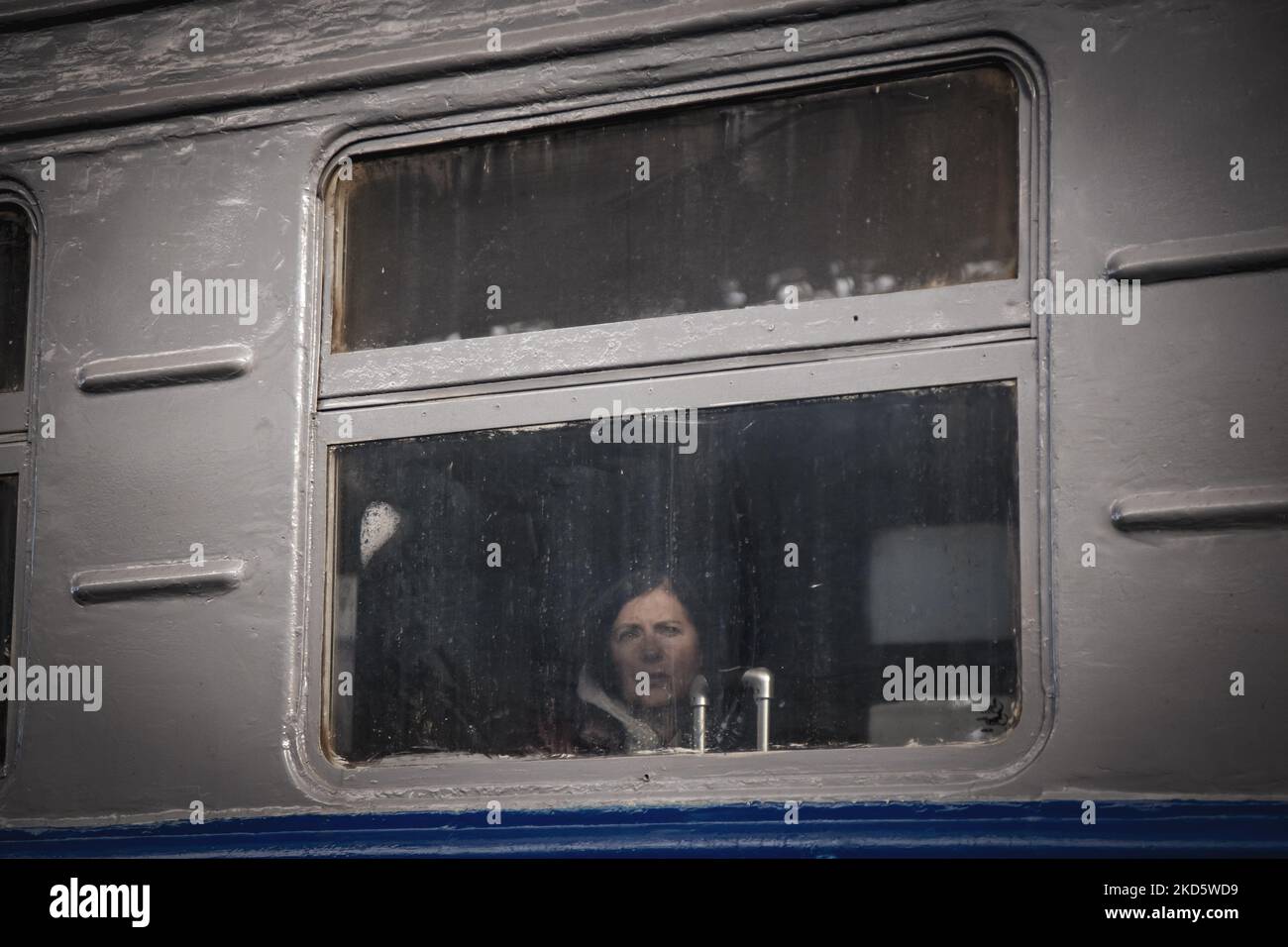 A young woman. People as seen through the train wagon window, waiting ...