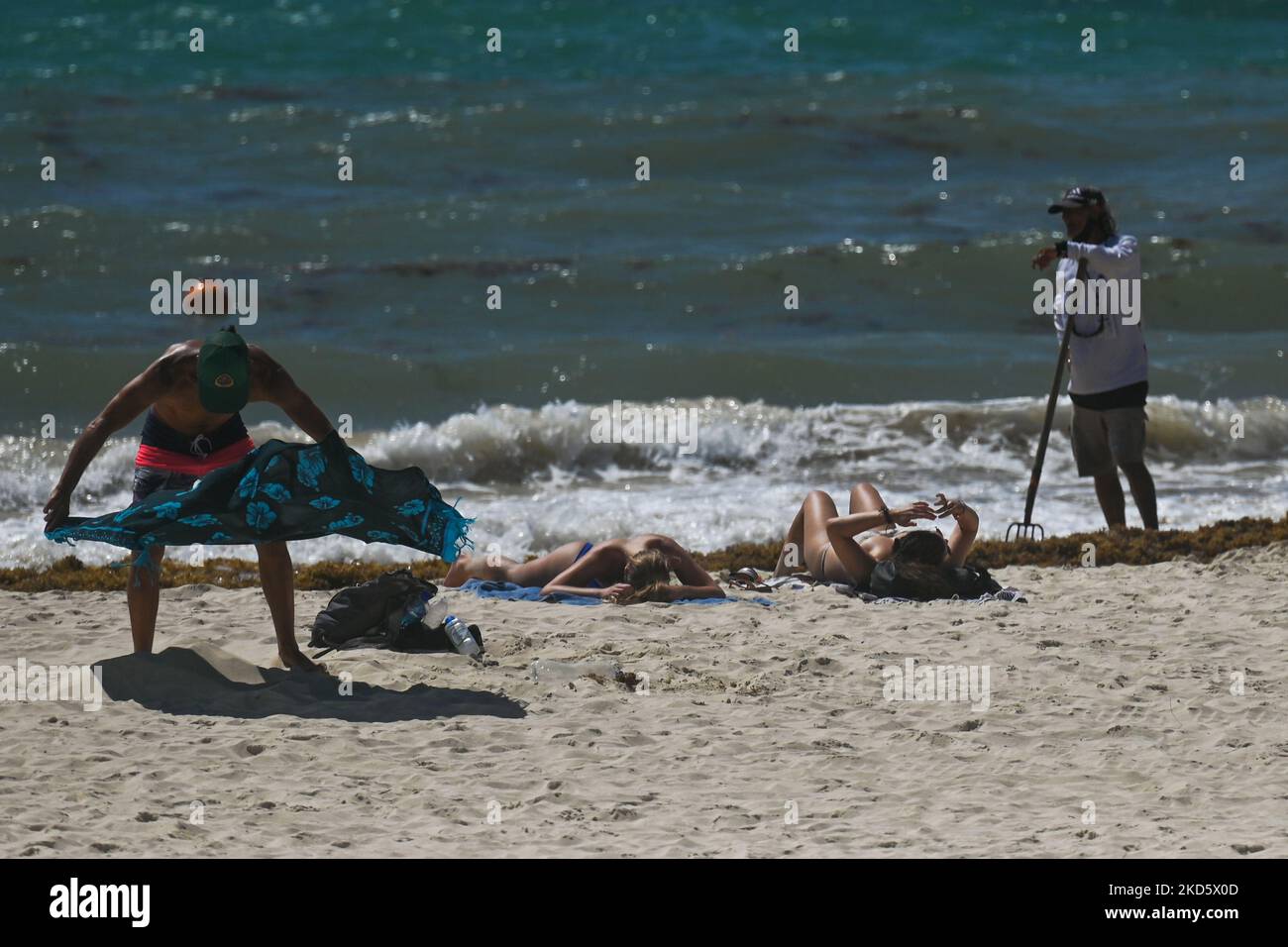 Seaweed cleaning on a busy beach in Playa del Carmen. On Tuesday, 22 ...