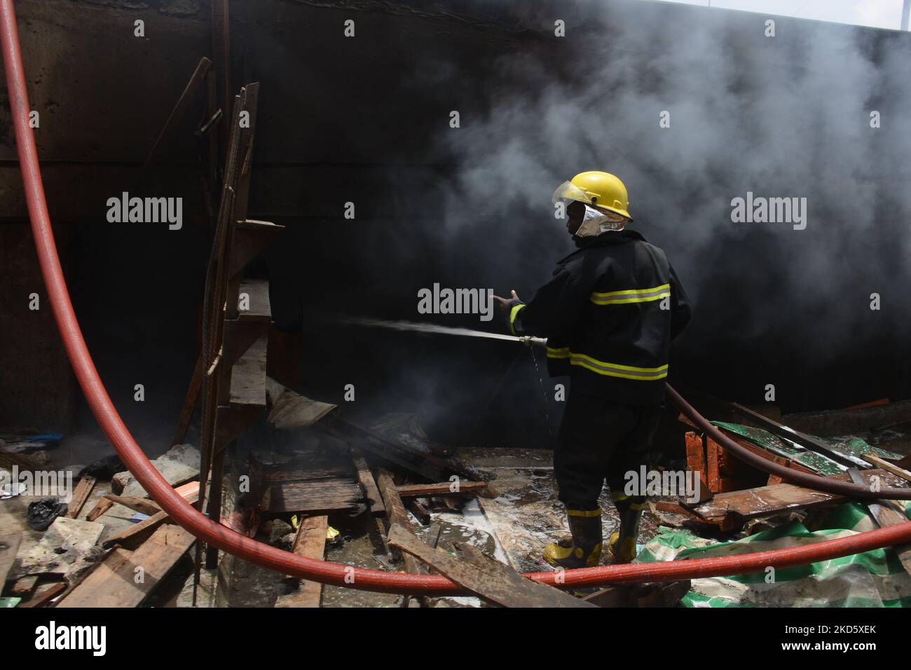 A firefighter tries to extinguish a burning fire under the Apongbon ...