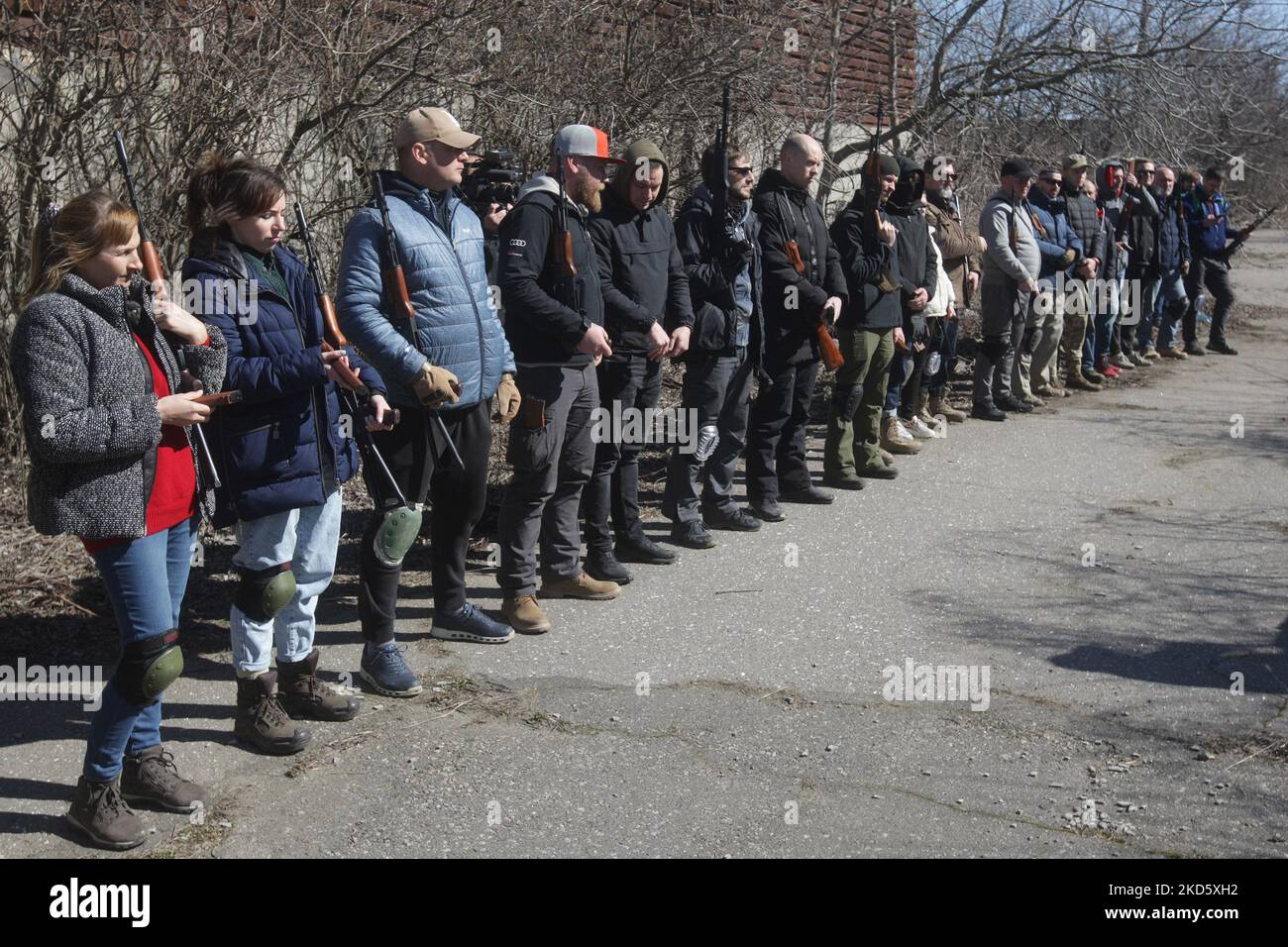 Local residents attend a free training for civilians in handling ...