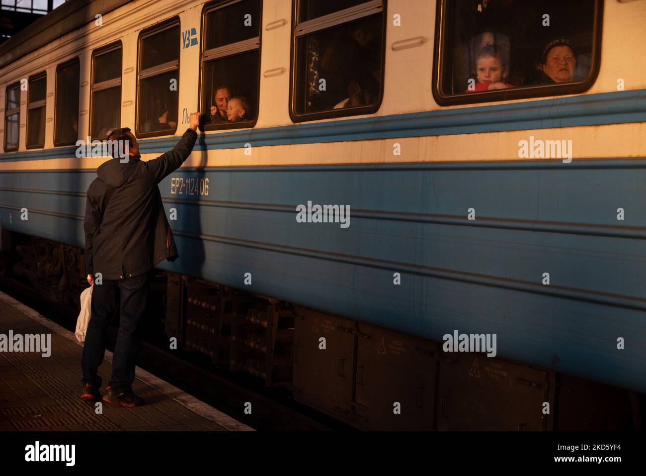 A man says good bye to his baby and wife on the train platform in Lviv ...