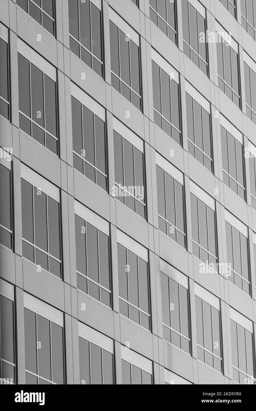 A vertical minimalistic grayscale of a modern office building exterior ...