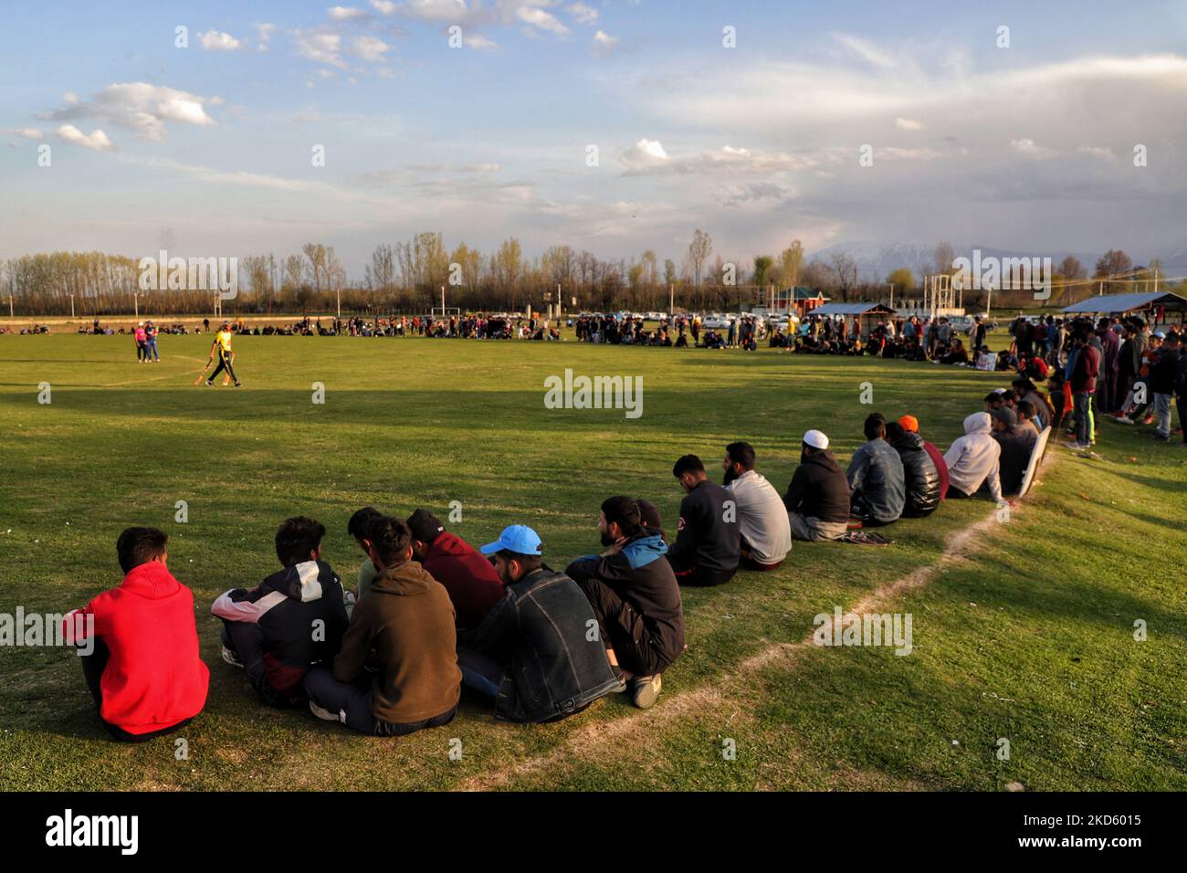 Cricket spectators watch a Live match on a sunny day in Sopore ...