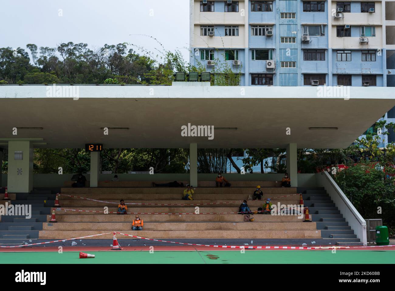Construction workers take a break on a football ground completely ...