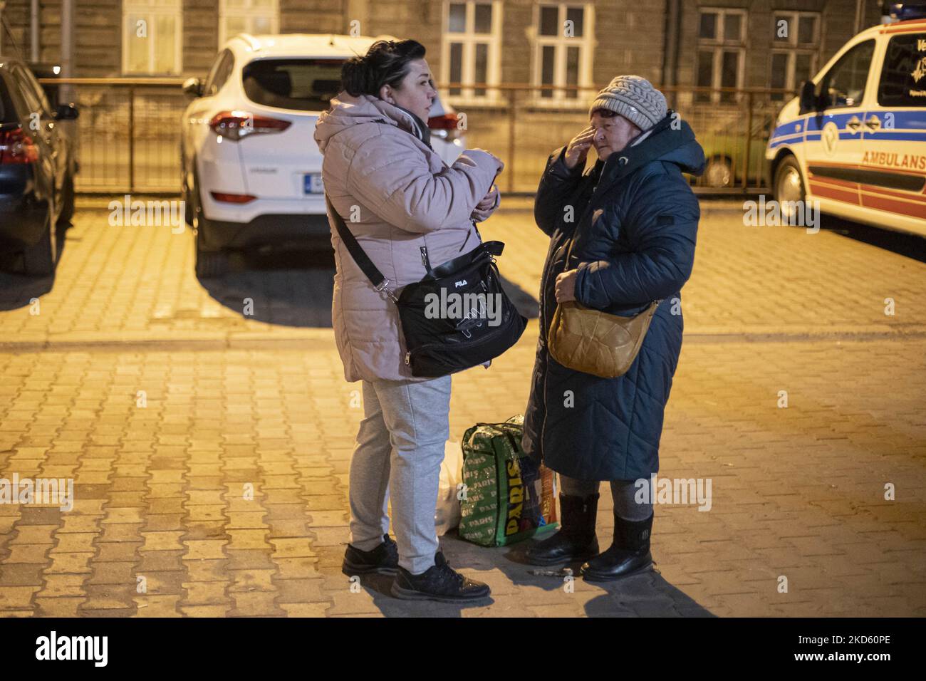 Old women cry and hug as they arrive safely in Poland. Refugees from ...