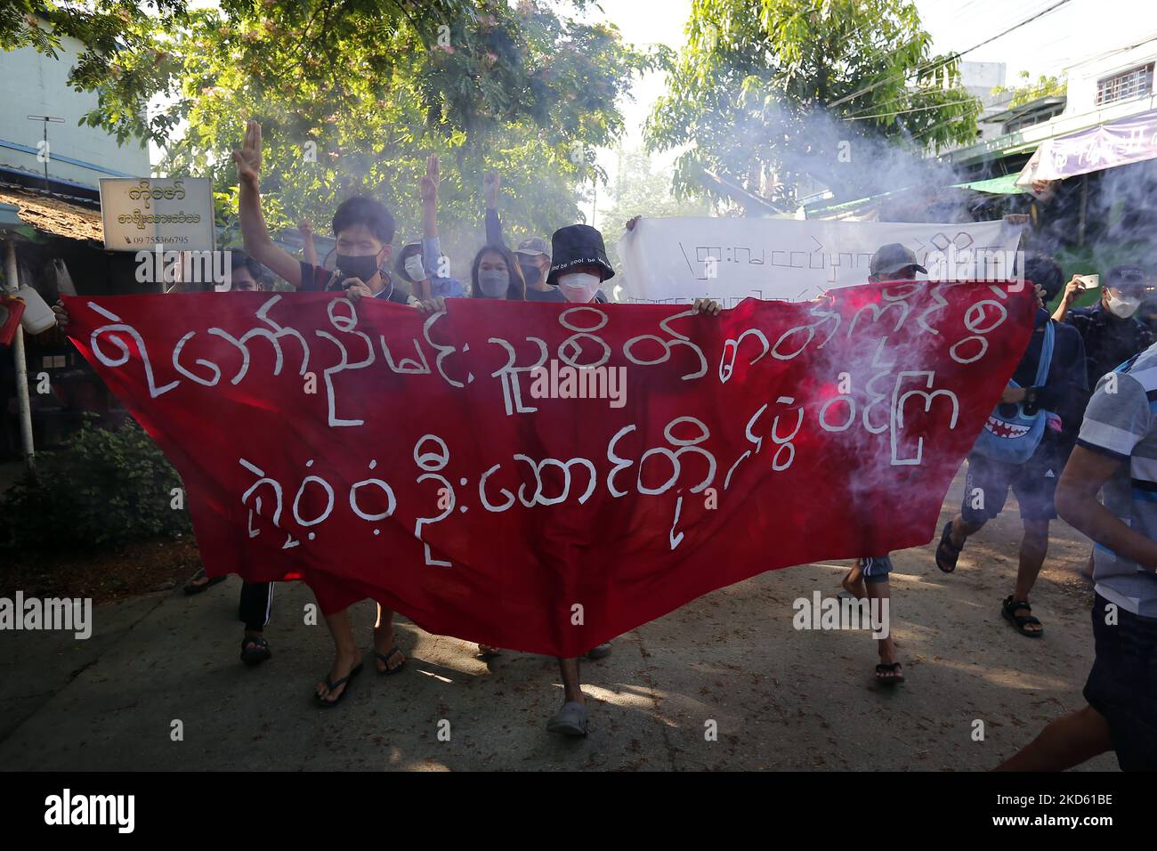 A group of young protesters shout slogansÂ and make the defiant three ...