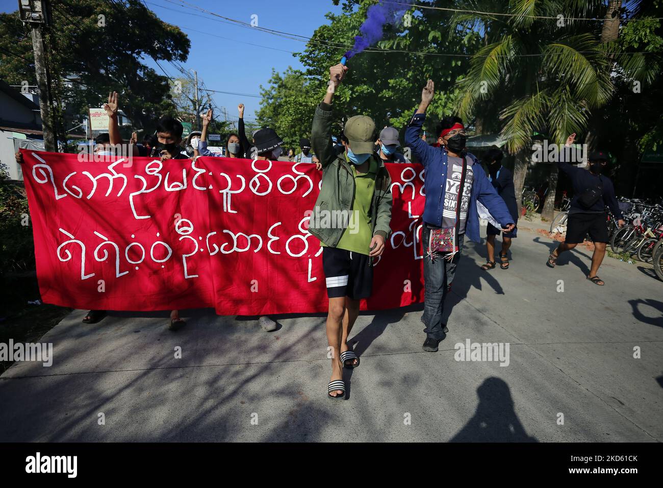 A group of young protesters shout slogansÂ and make the defiant three ...