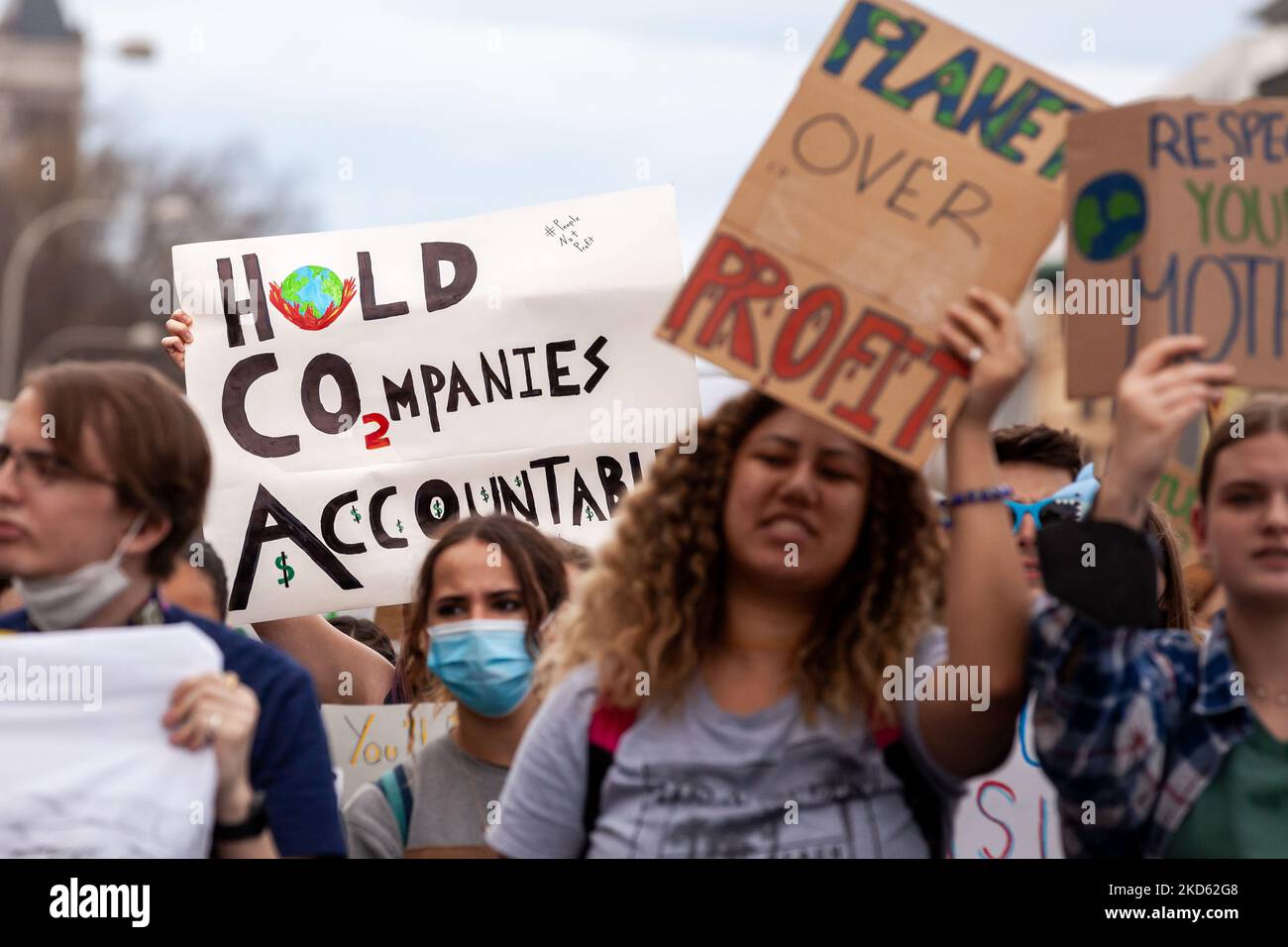 A protester carries a sign calling for companies to be held accountable ...