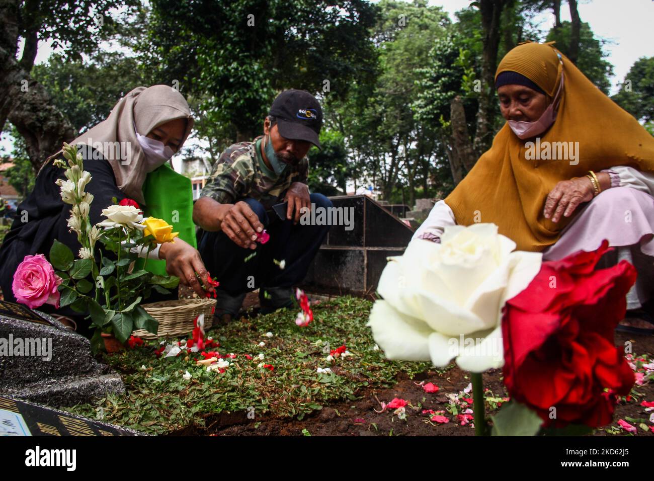 An Indonesian Muslim is seen sowing flowers during the Nyadran ritual ...