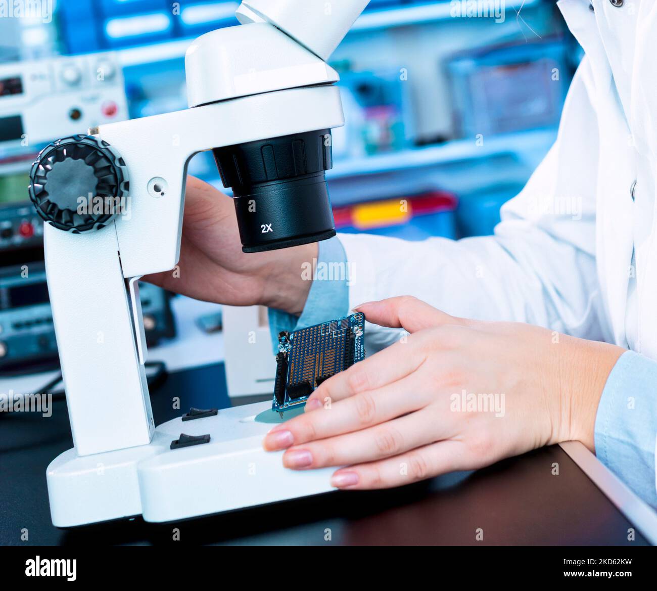 A young woman is testing an electronic module for the production of ...