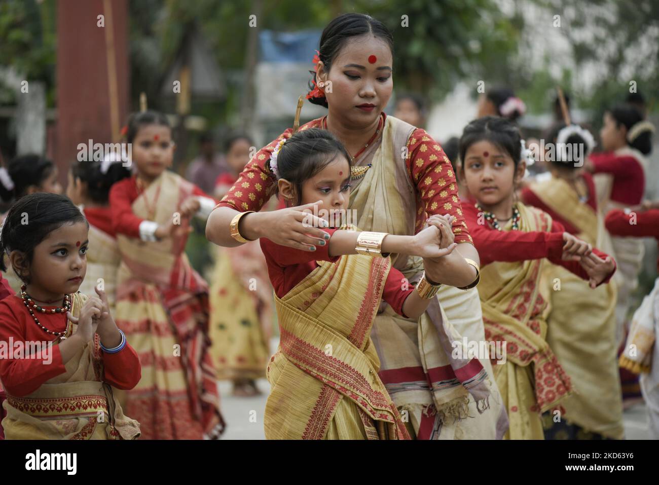 Children learning Bihu dance from a mentor in a traditional Bihu Dance ...
