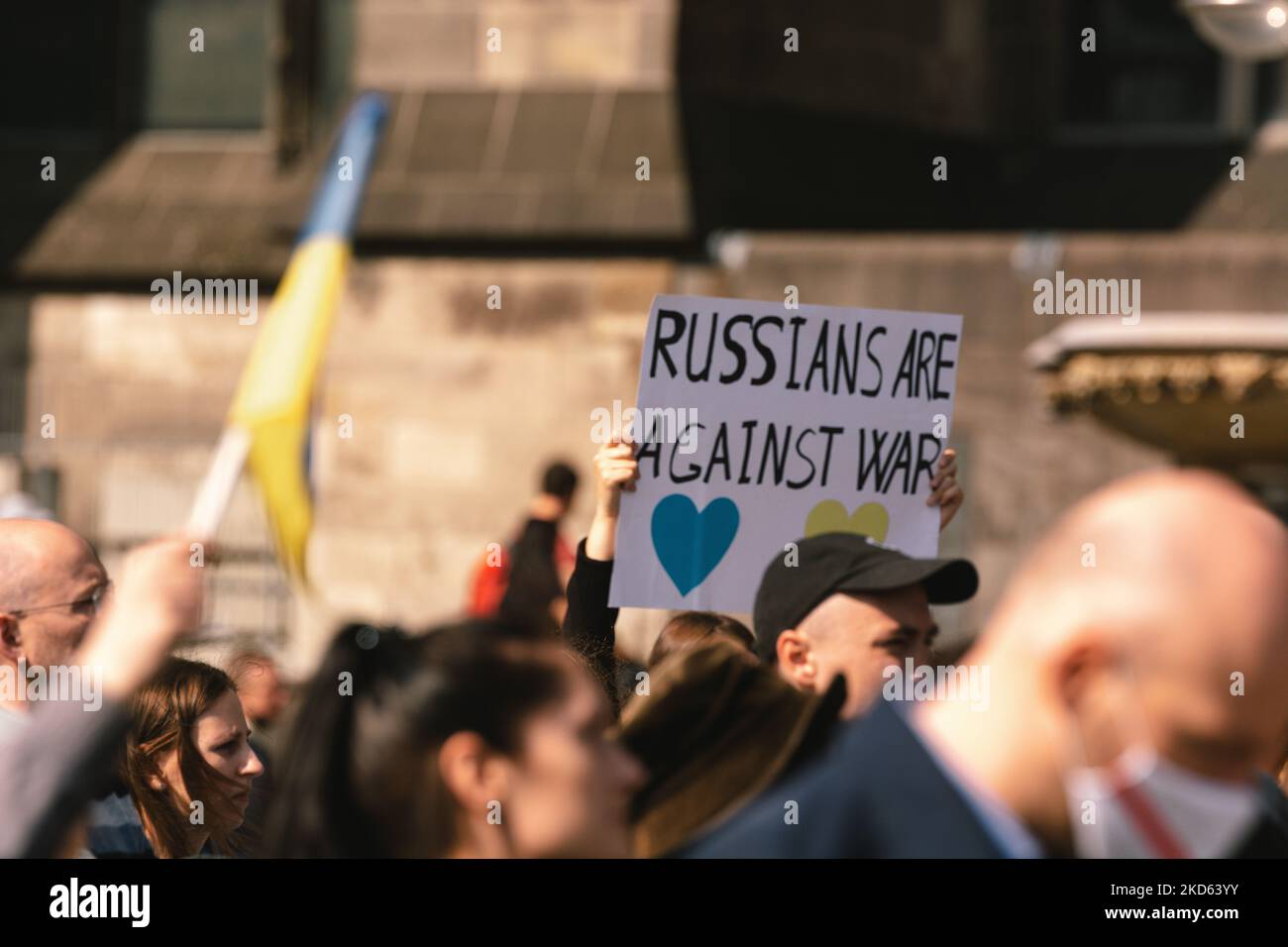 A Protesters holds the signs " sRussians are against war" in front of ...