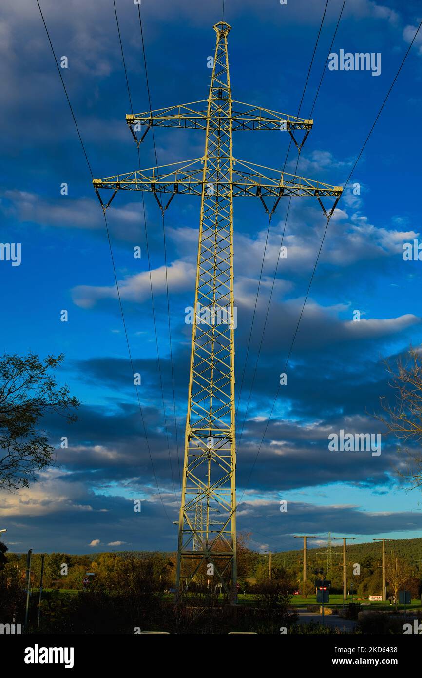 A vertical shot of utility poles over a beautiful background of a ...