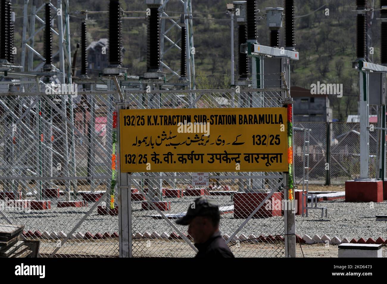 Workers are seen during Electric Train Run at Baramulla Railway Station ...