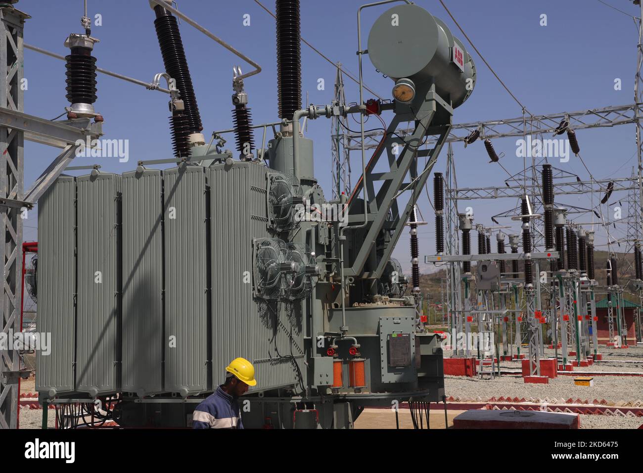 Workers are seen during Electric Train Run at Baramulla Railway Station ...
