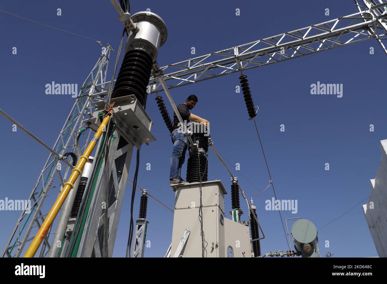 Workers are seen during Electric Train Run at Baramulla Railway Station ...