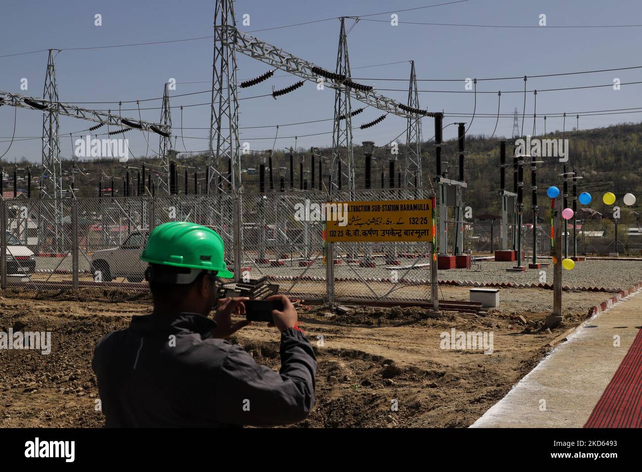 Workers are seen during Electric Train Run at Baramulla Railway Station ...